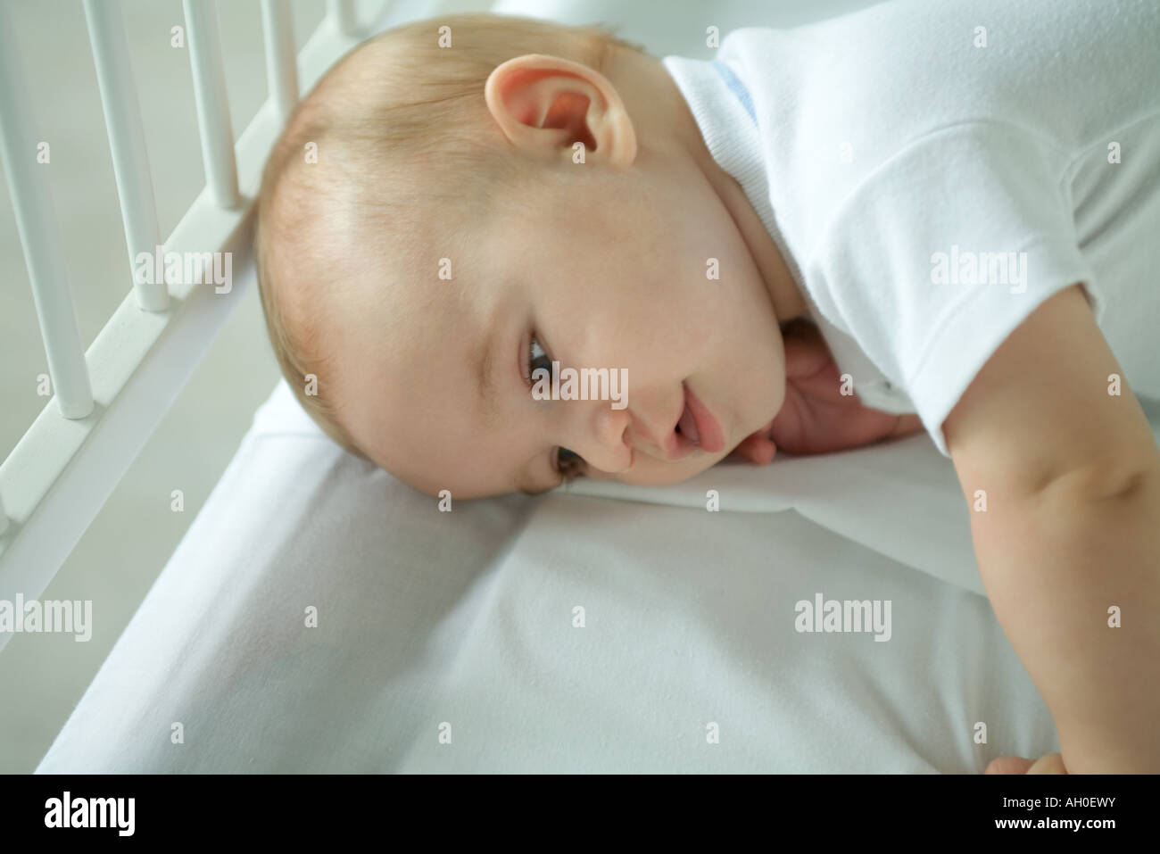 Baby in crib, lying on side, head and shoulders Stock Photo - Alamy