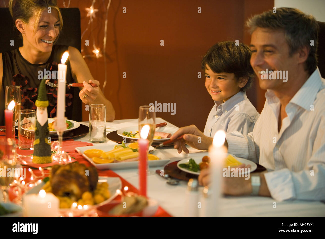 Family eating Christmas dinner, smiling Stock Photo - Alamy