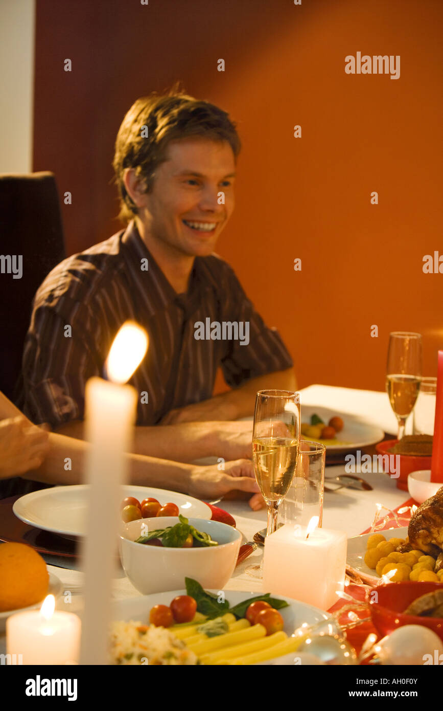 Man sitting at dinner table, smiling Stock Photo - Alamy
