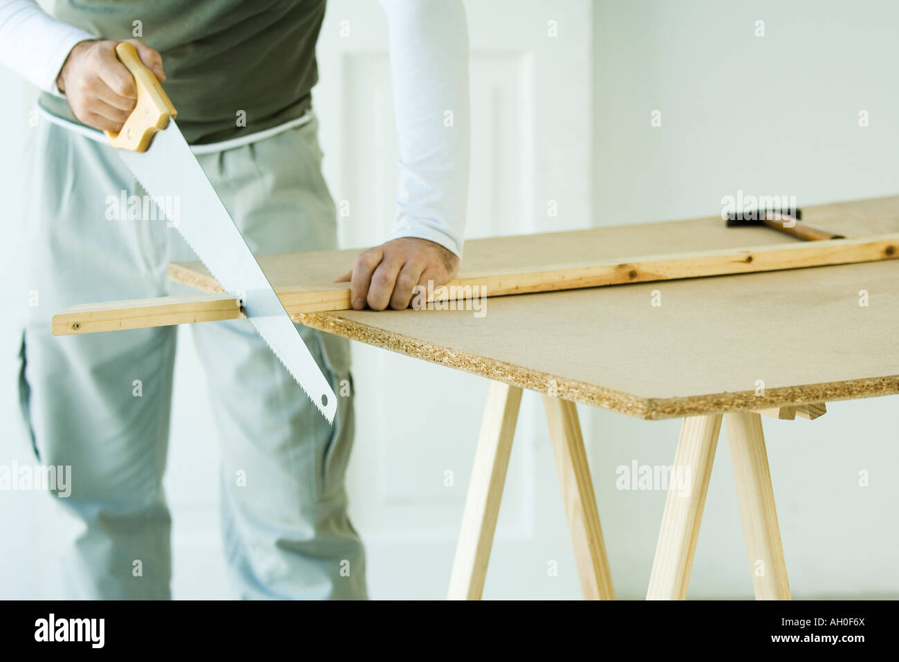 Man holding saw hammer wood hi-res stock photography and images - Alamy