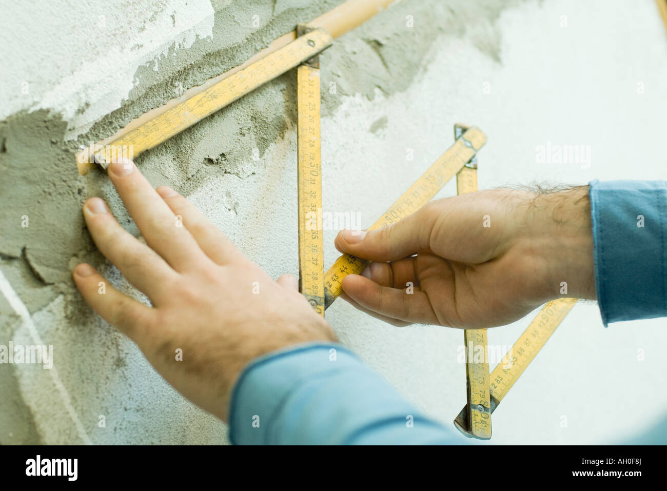 Man measuring with folding ruler, cropped view of hands Stock Photo - Alamy