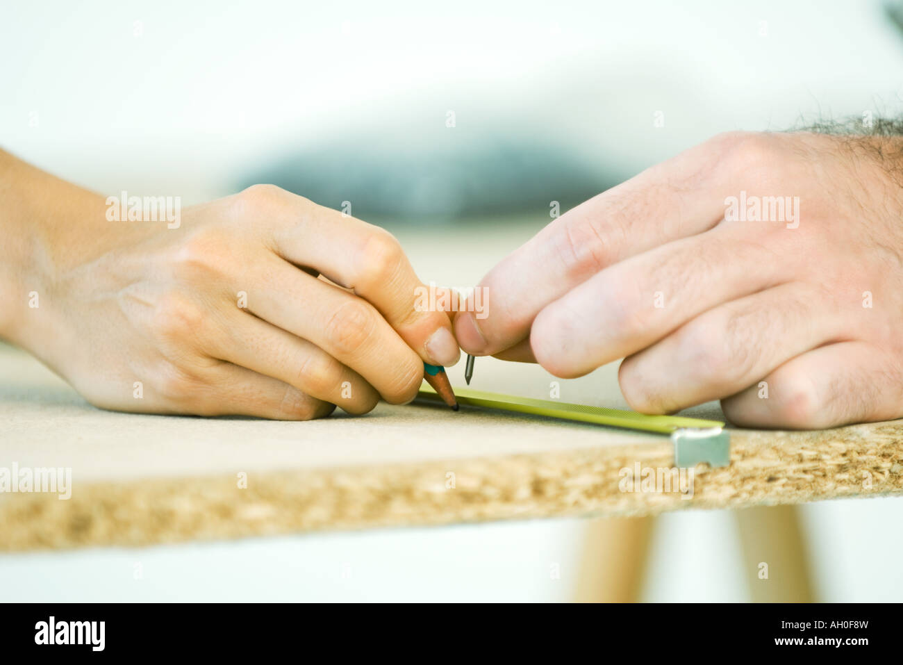 Couple measuring wood, cropped view of hands Stock Photo - Alamy