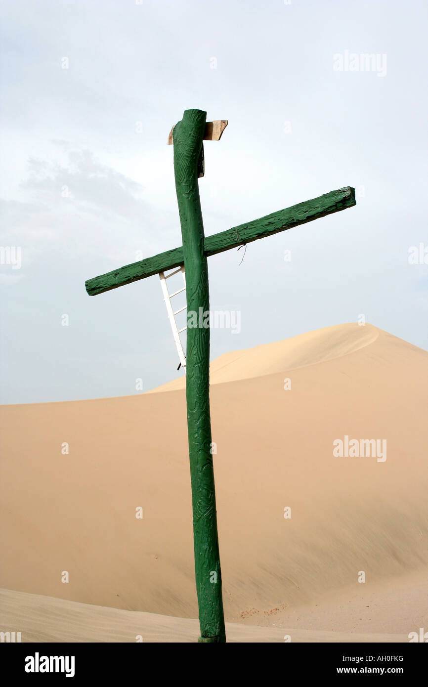 Lonely cross standing in the middle of the desert in Peru Nothing else ...