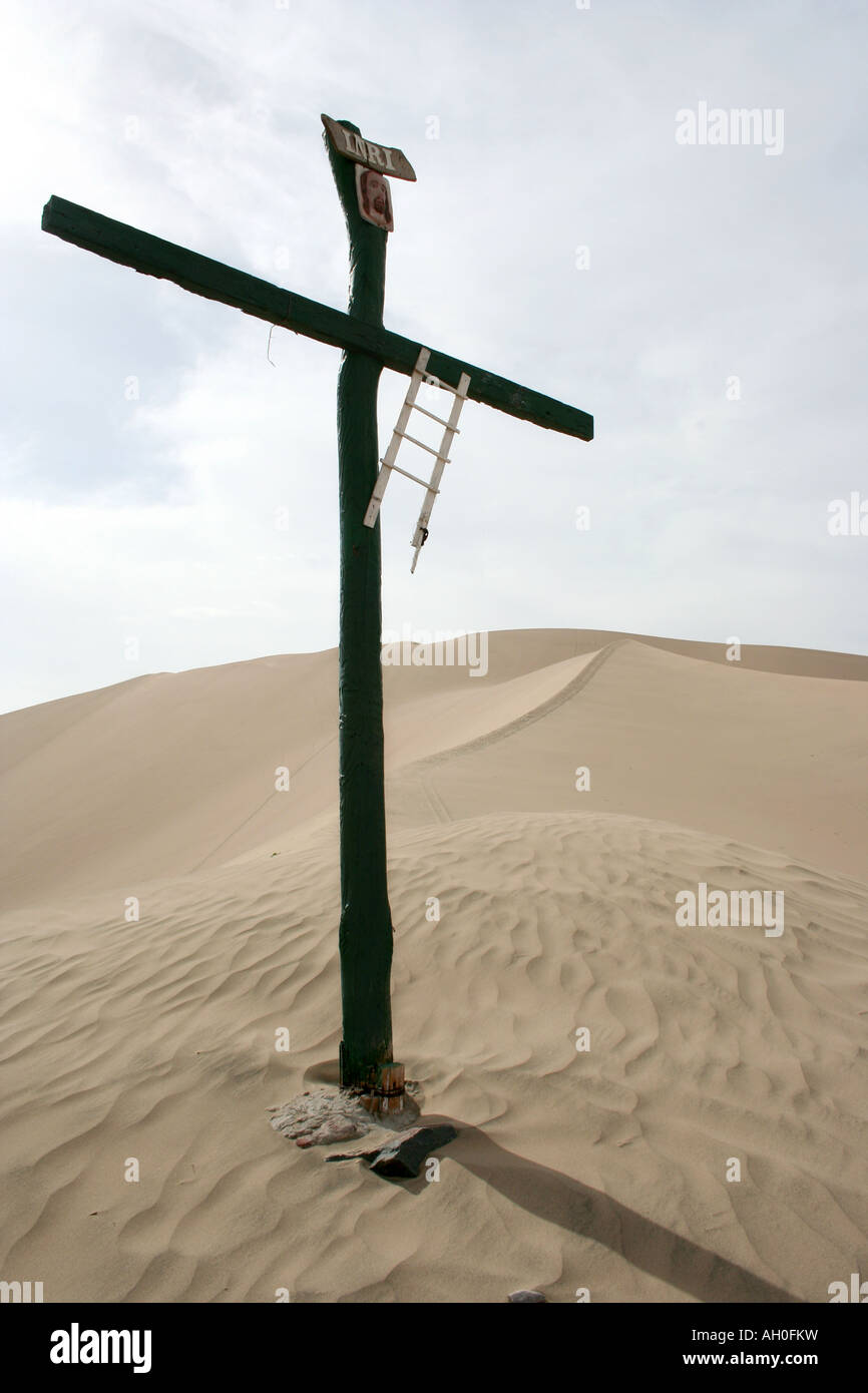 Lonely cross standing in the middle of the desert in Peru Nothing else ...