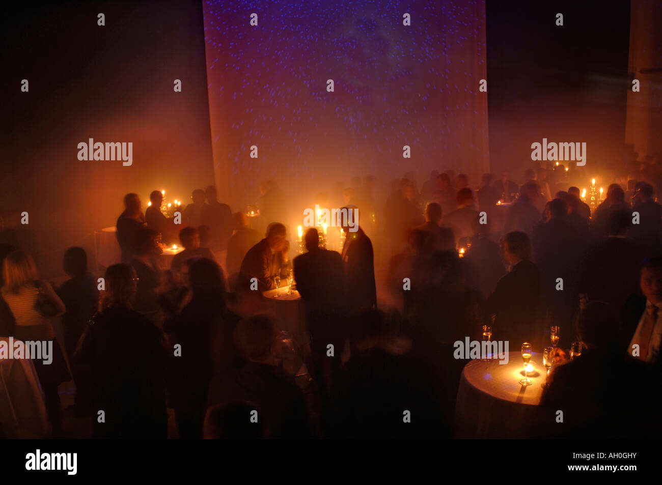 People at a party with spectacular interior lighting with candles at ...