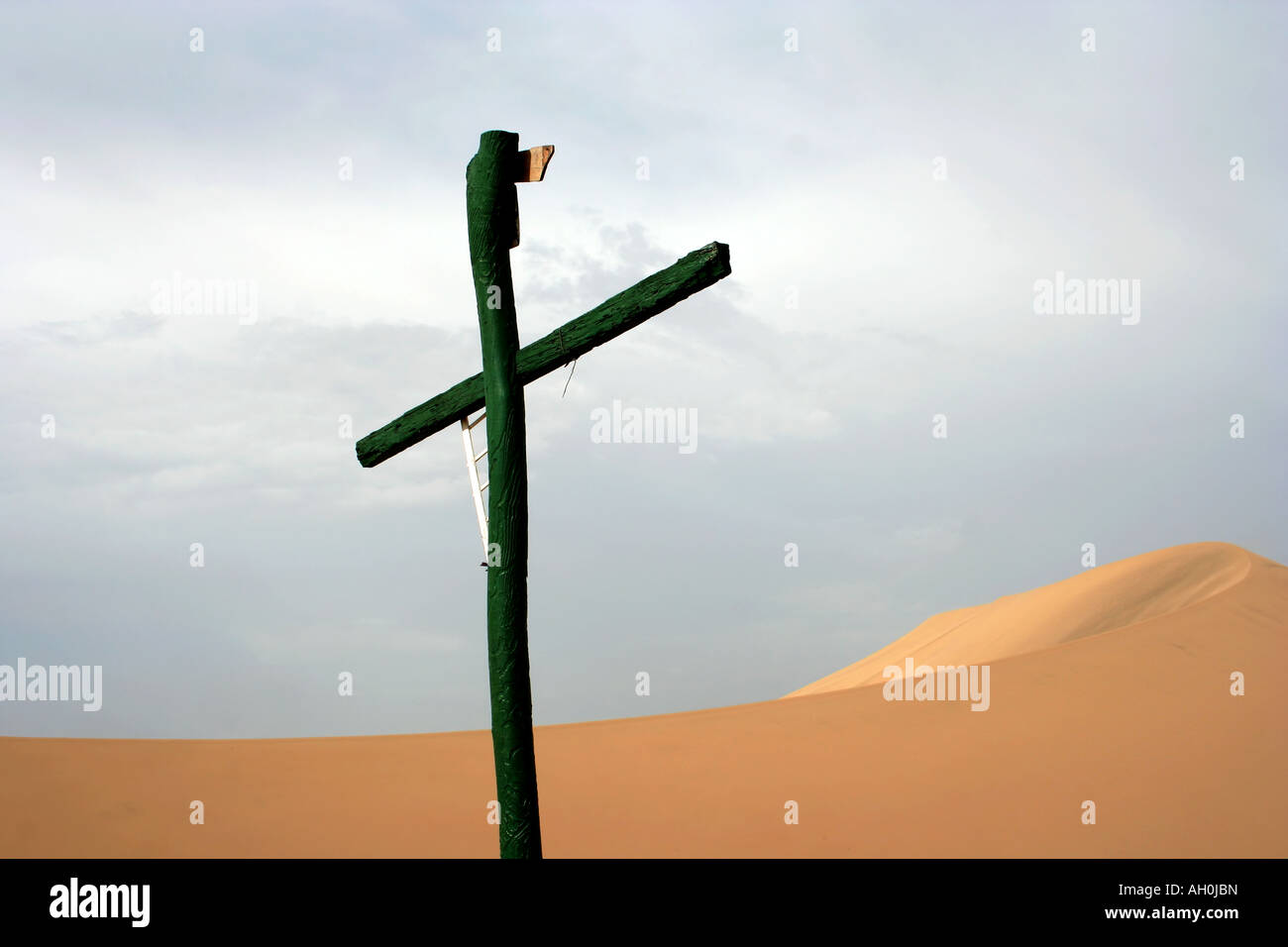 Lonely cross standing in the middle of the desert in Peru Nothing else ...