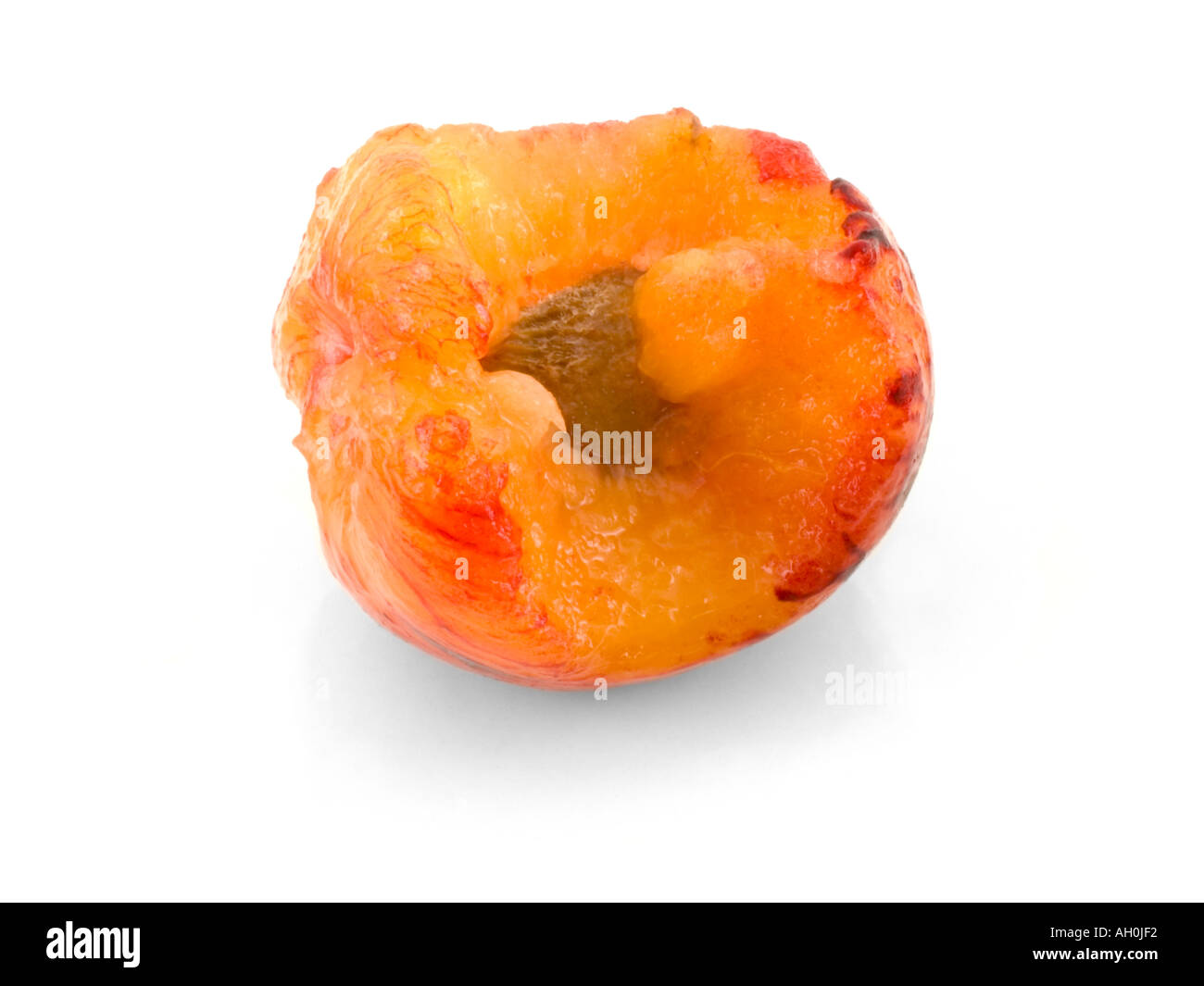 Plum with a bite missing against a white background Stock Photo - Alamy