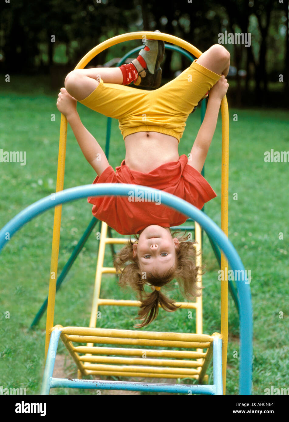 Child hanging upside down on climbing hi-res stock photography and images - Alamy