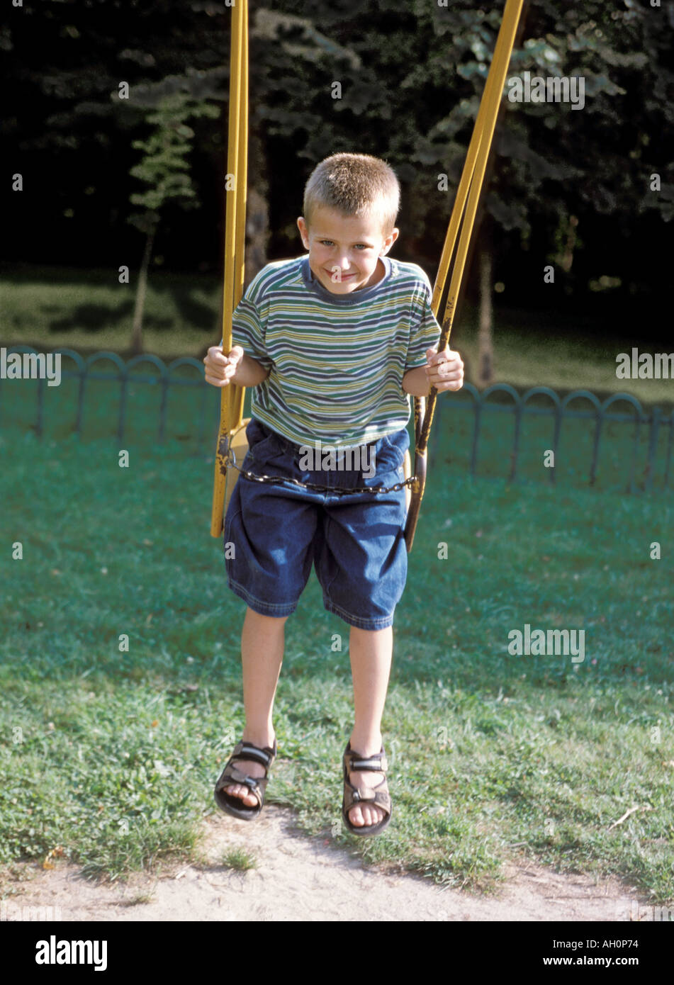 boy swinging smiling Stock Photo - Alamy