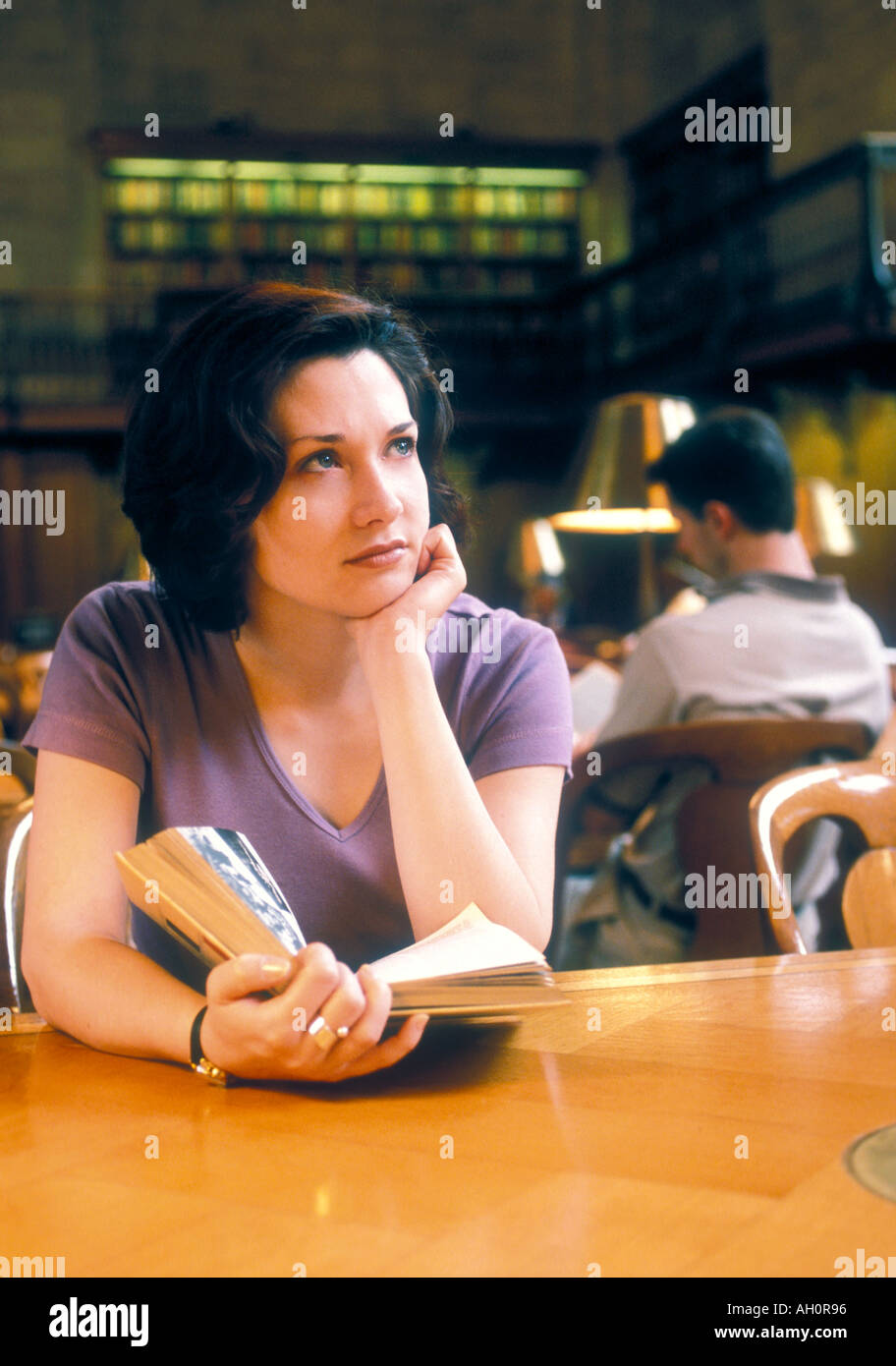 Public Library Woman with book thinking man in background Stock Photo ...