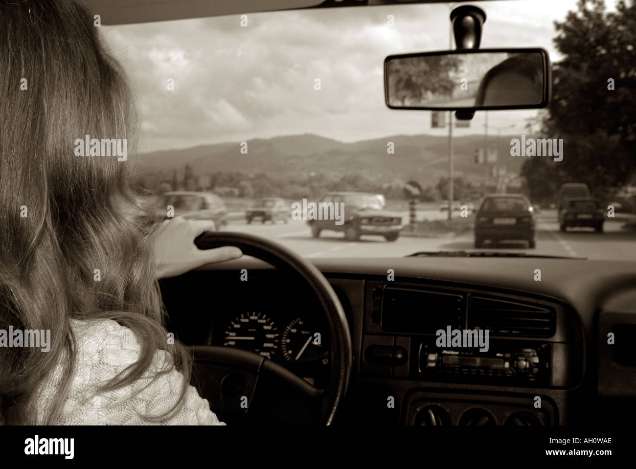 Driving woman drives car along hi-res stock photography and images - Alamy