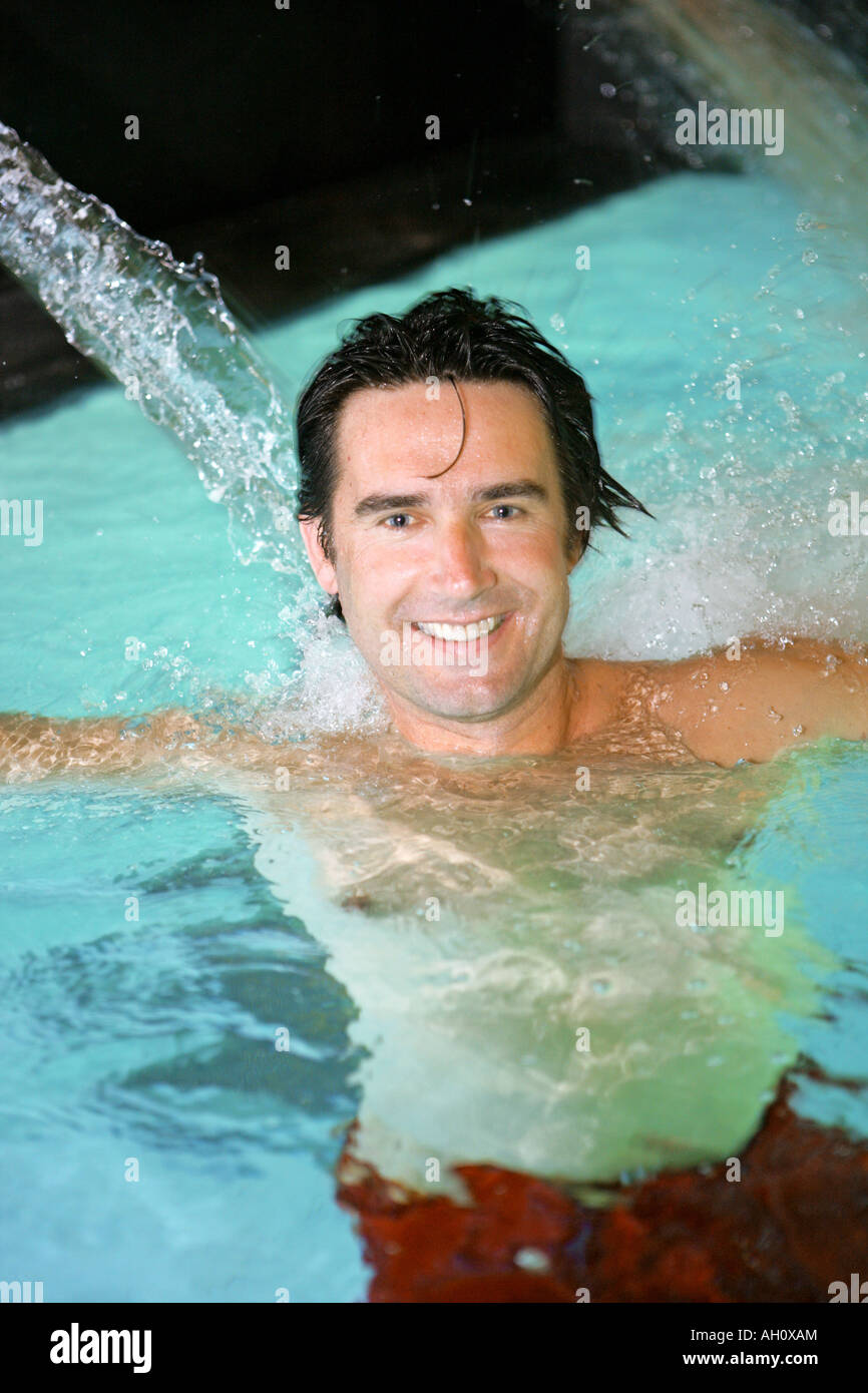man relaxe in a swimming pool at a spa Stock Photo - Alamy