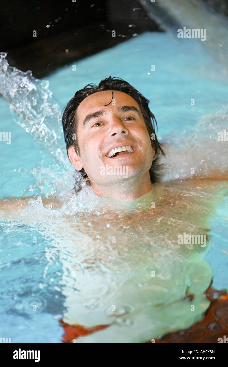 man relaxe in a swimming pool at a spa Stock Photo - Alamy