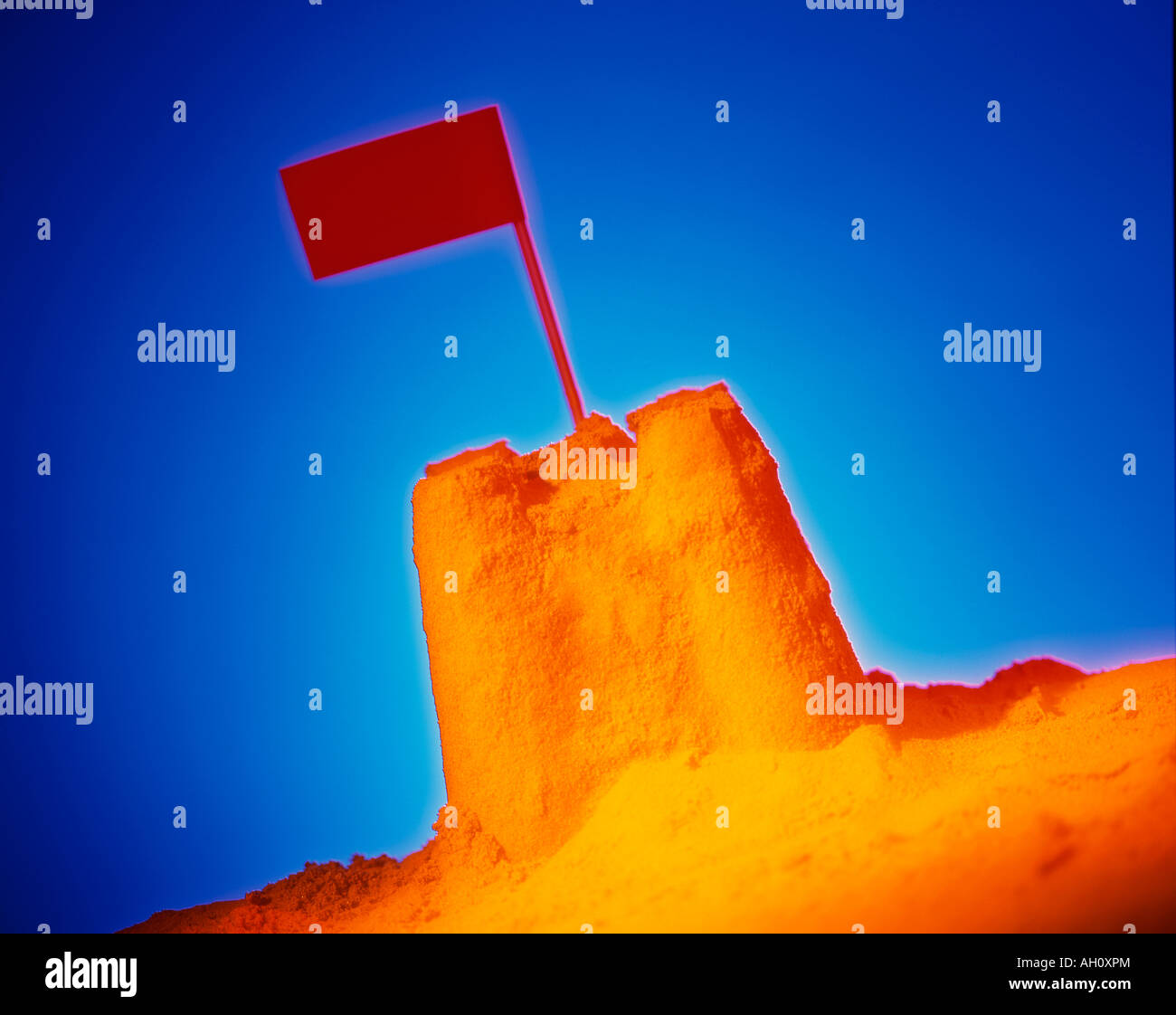 sandcastle with red flag Stock Photo - Alamy
