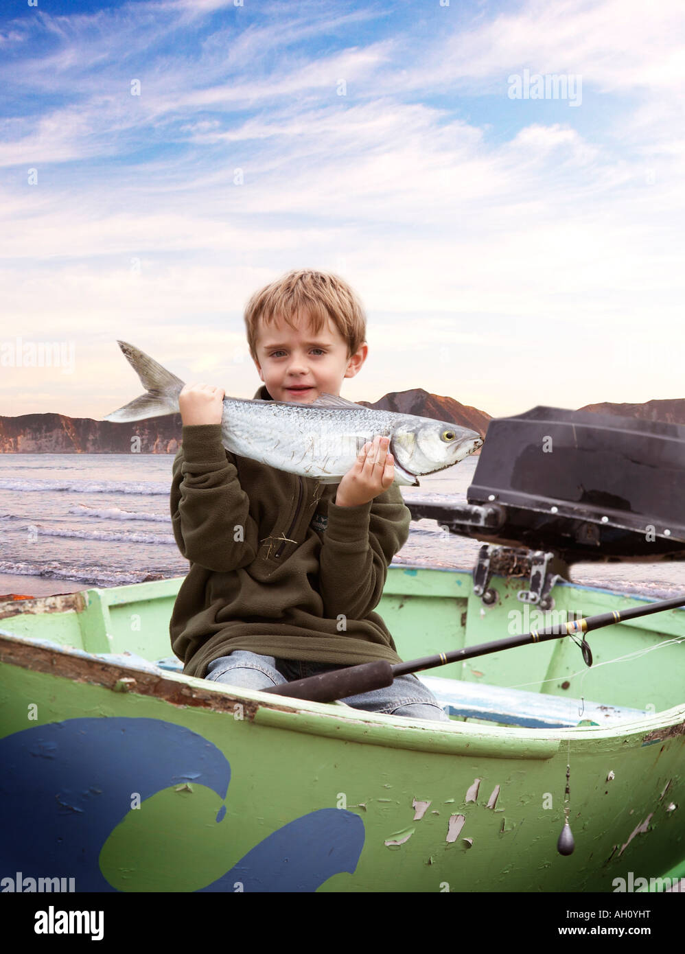boy 7 with fish in boat Stock Photo - Alamy
