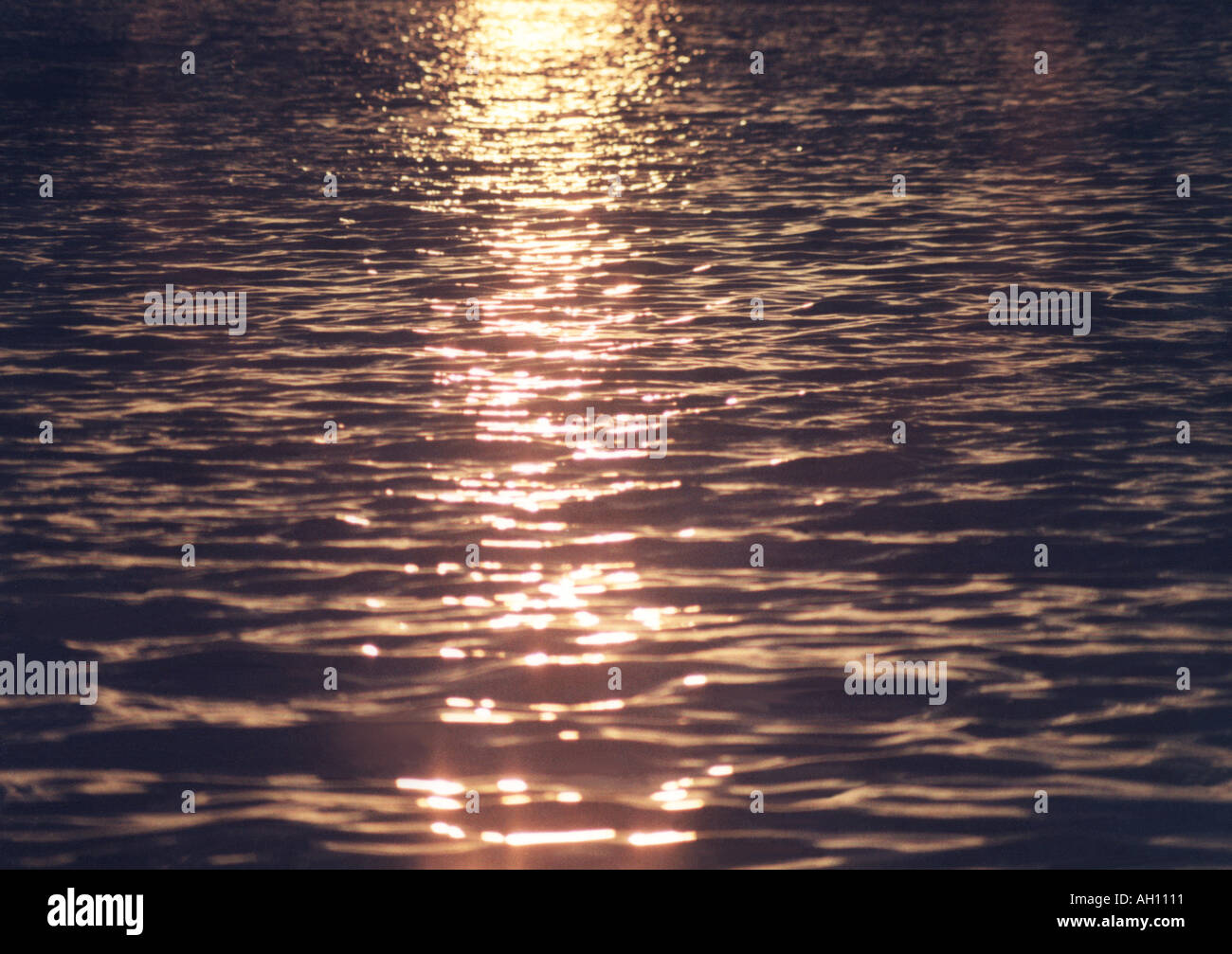 Water texture with sunset reflection in waves Stock Photo - Alamy
