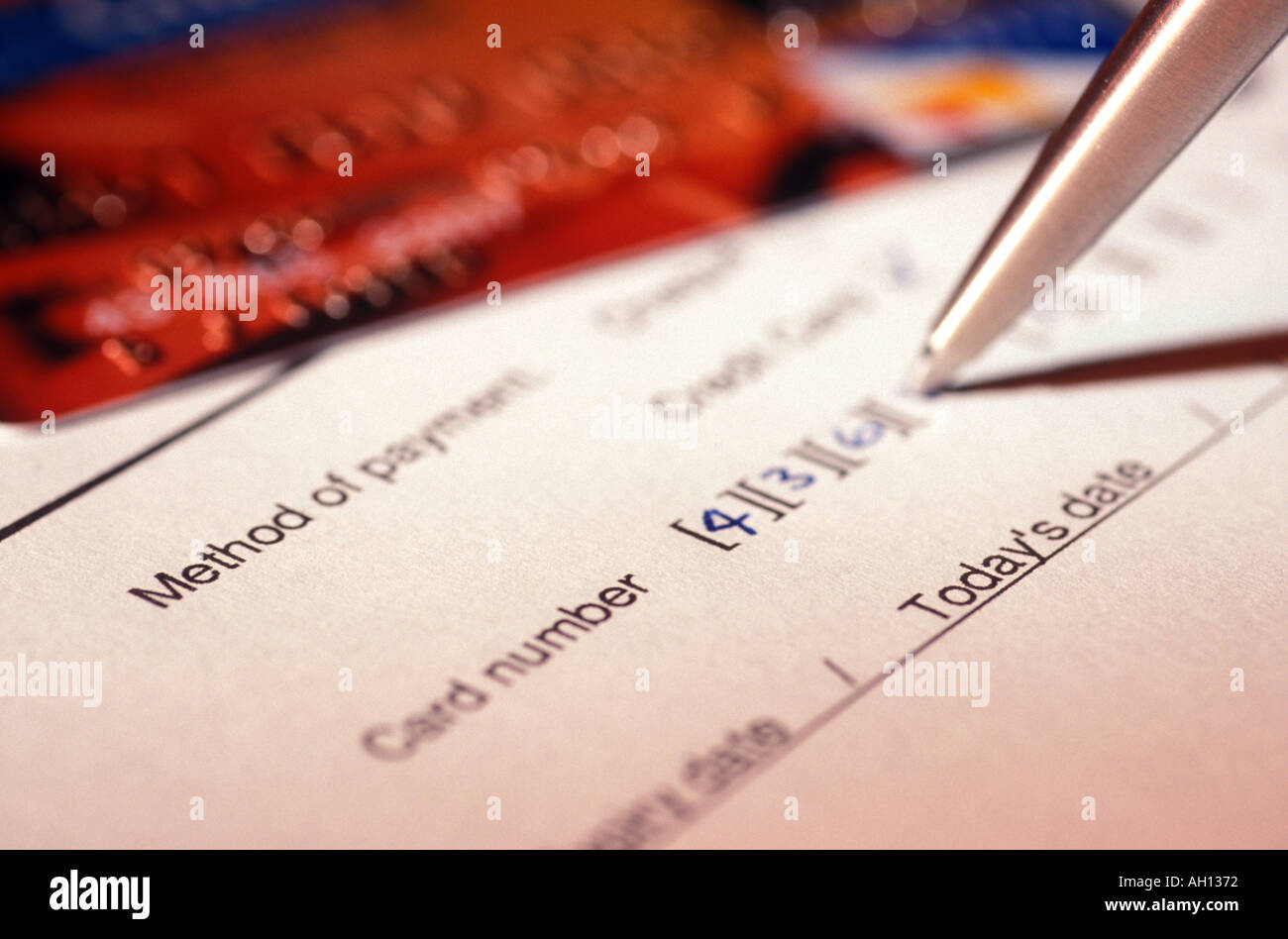 Writing credit card details on application form Stock Photo - Alamy