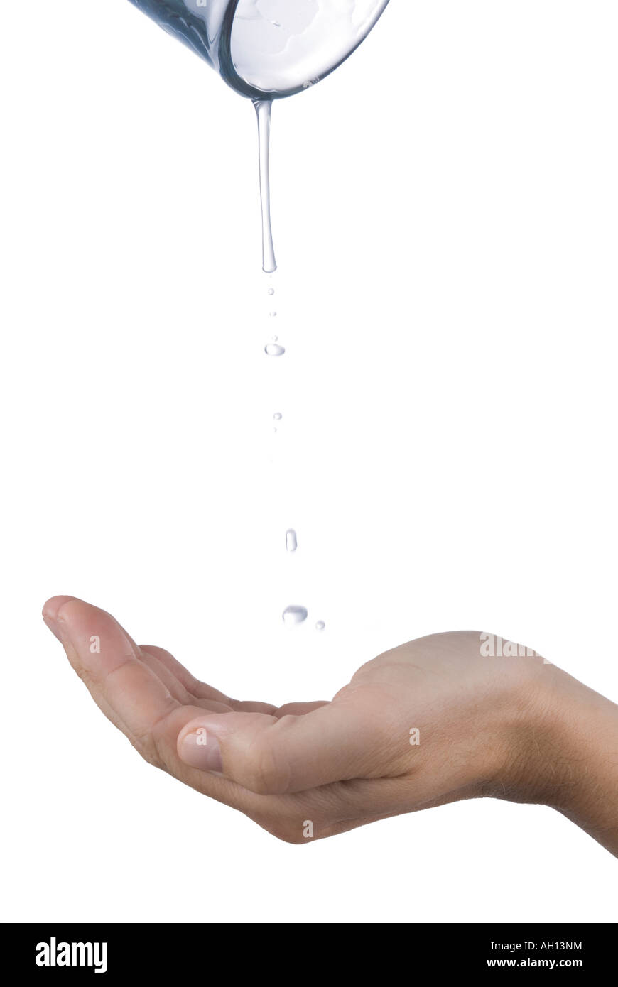 Water is splashing out of a glass into a hand Stock Photo - Alamy