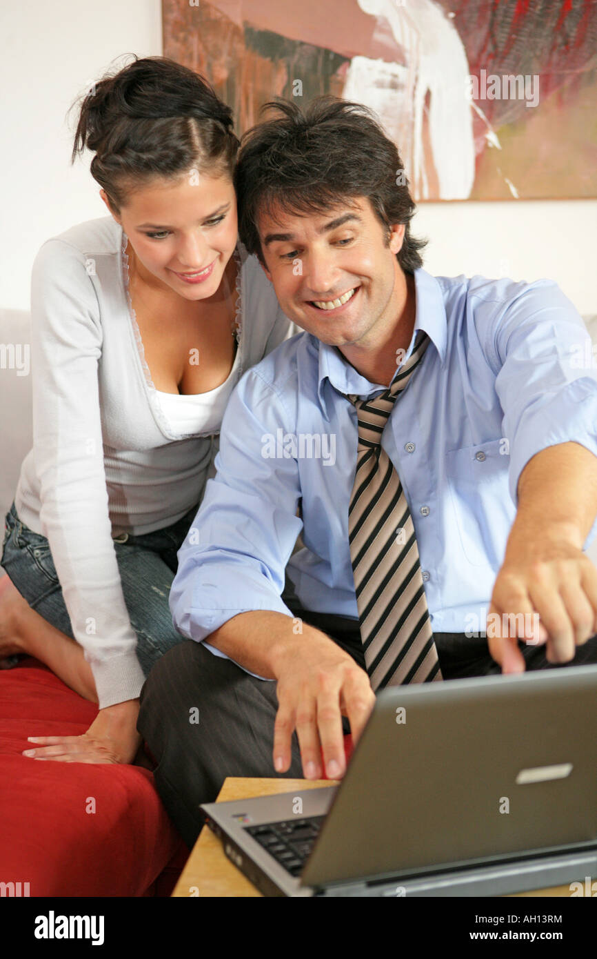 Couple using laptop computer at home Stock Photo - Alamy
