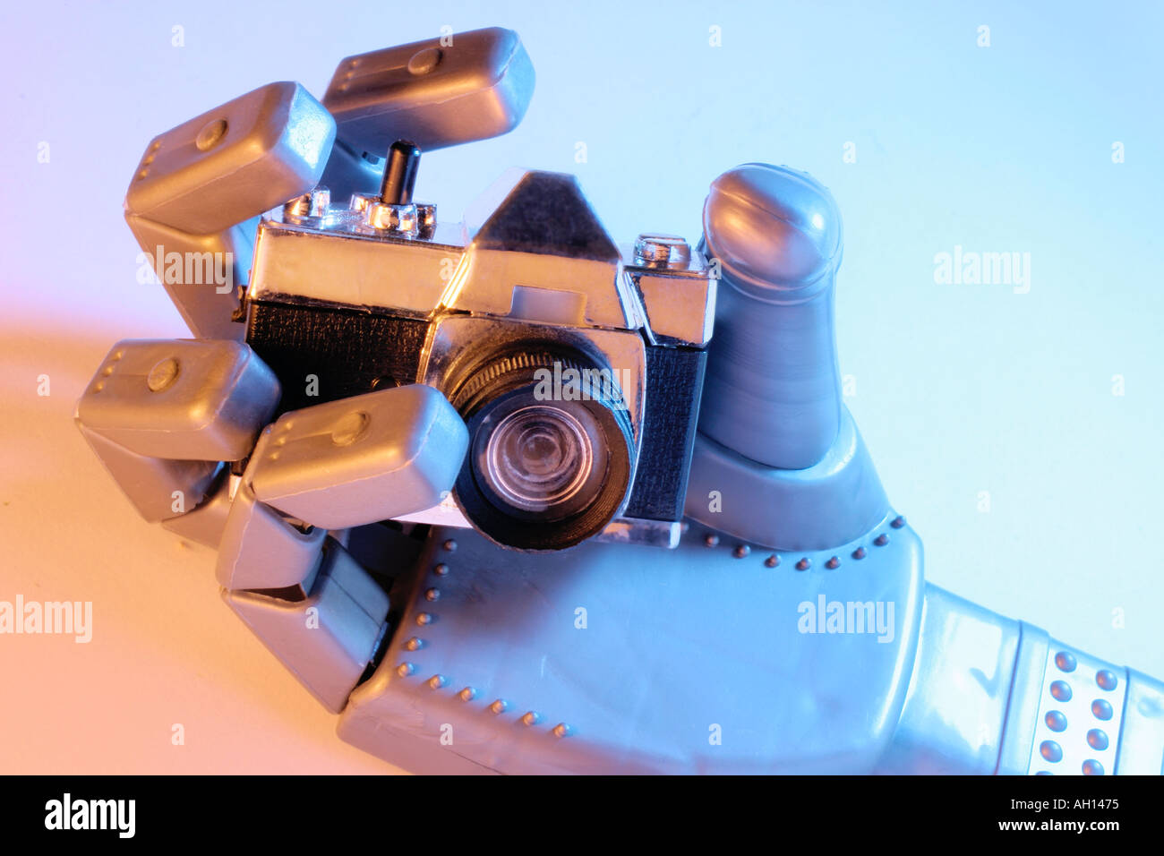 Robot Hand Holding Toy Camera Stock Photo - Alamy