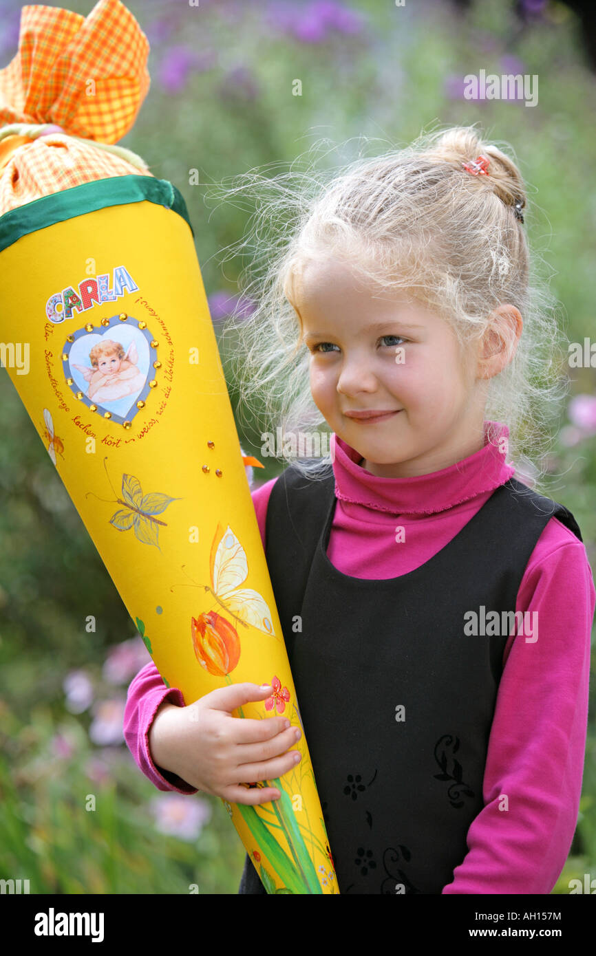 pretty blond girl with schoolcone paper funnel Stock Photo - Alamy