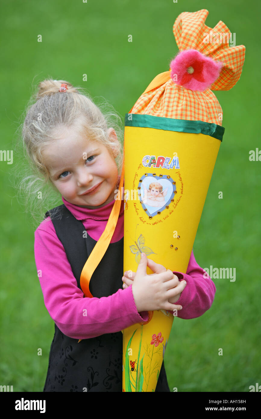 pretty blond girl with schoolcone paper funnel Stock Photo - Alamy