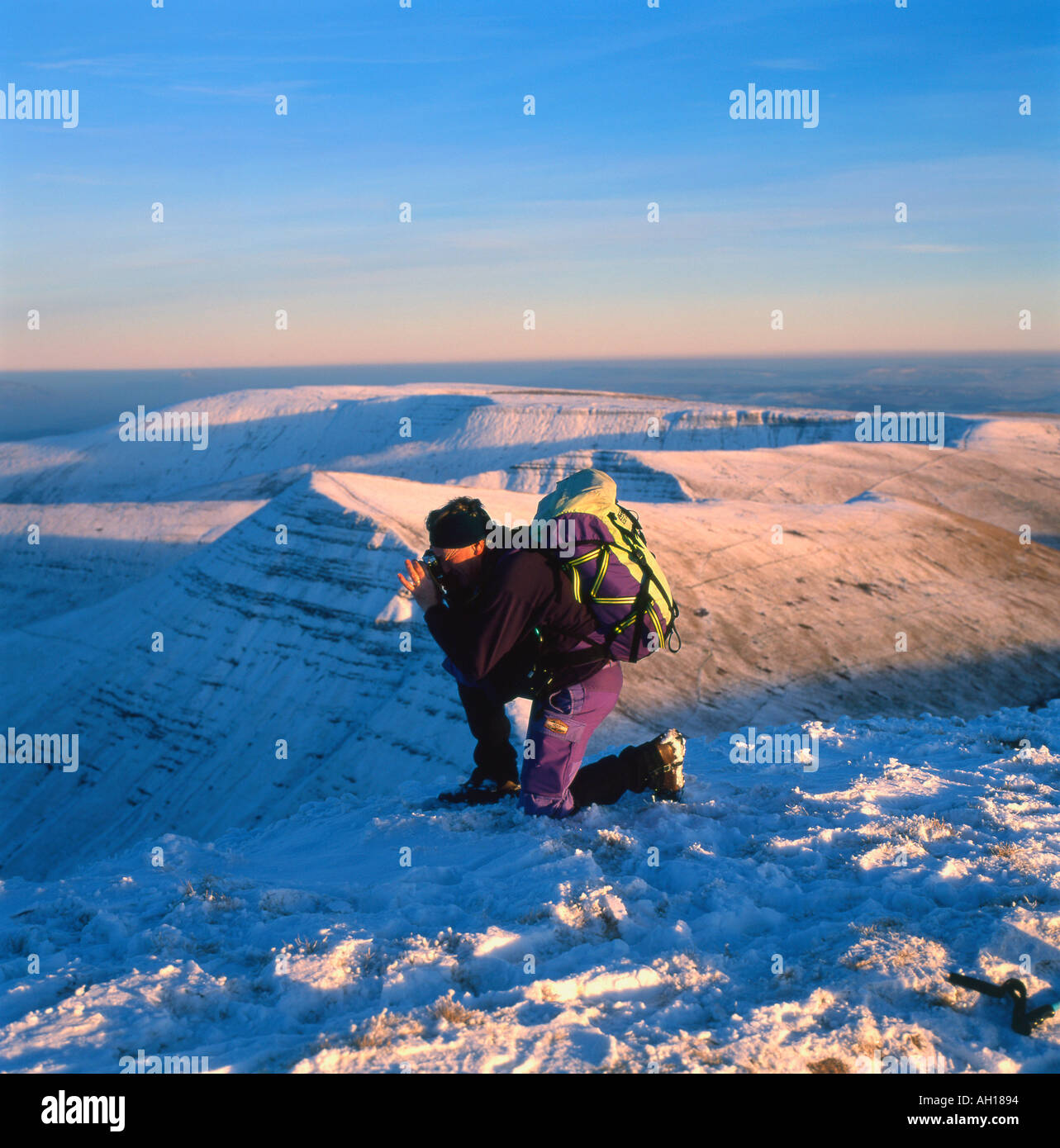 A photographer on Pen y Fan summit Corn Du in distance Brecon Beacons ...