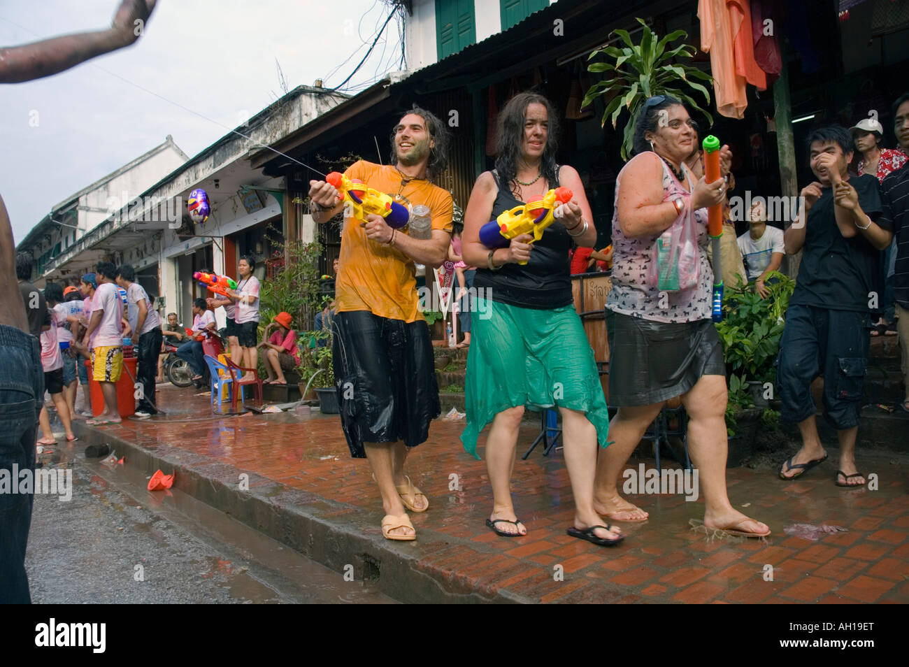 Tourists with large water pistols participating the communal water ...