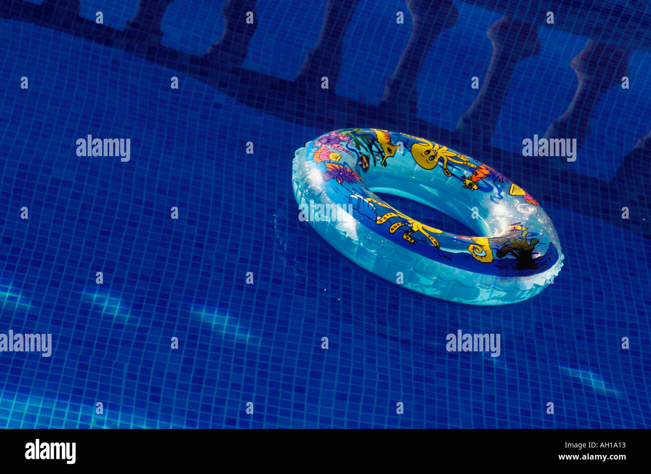 Swimming pool float and reflections Stock Photo - Alamy