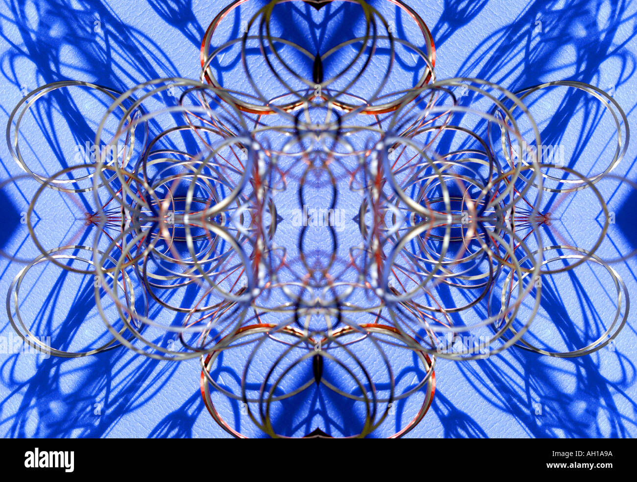 blue design taken from a bend out of shape metal slinky Stock Photo - Alamy