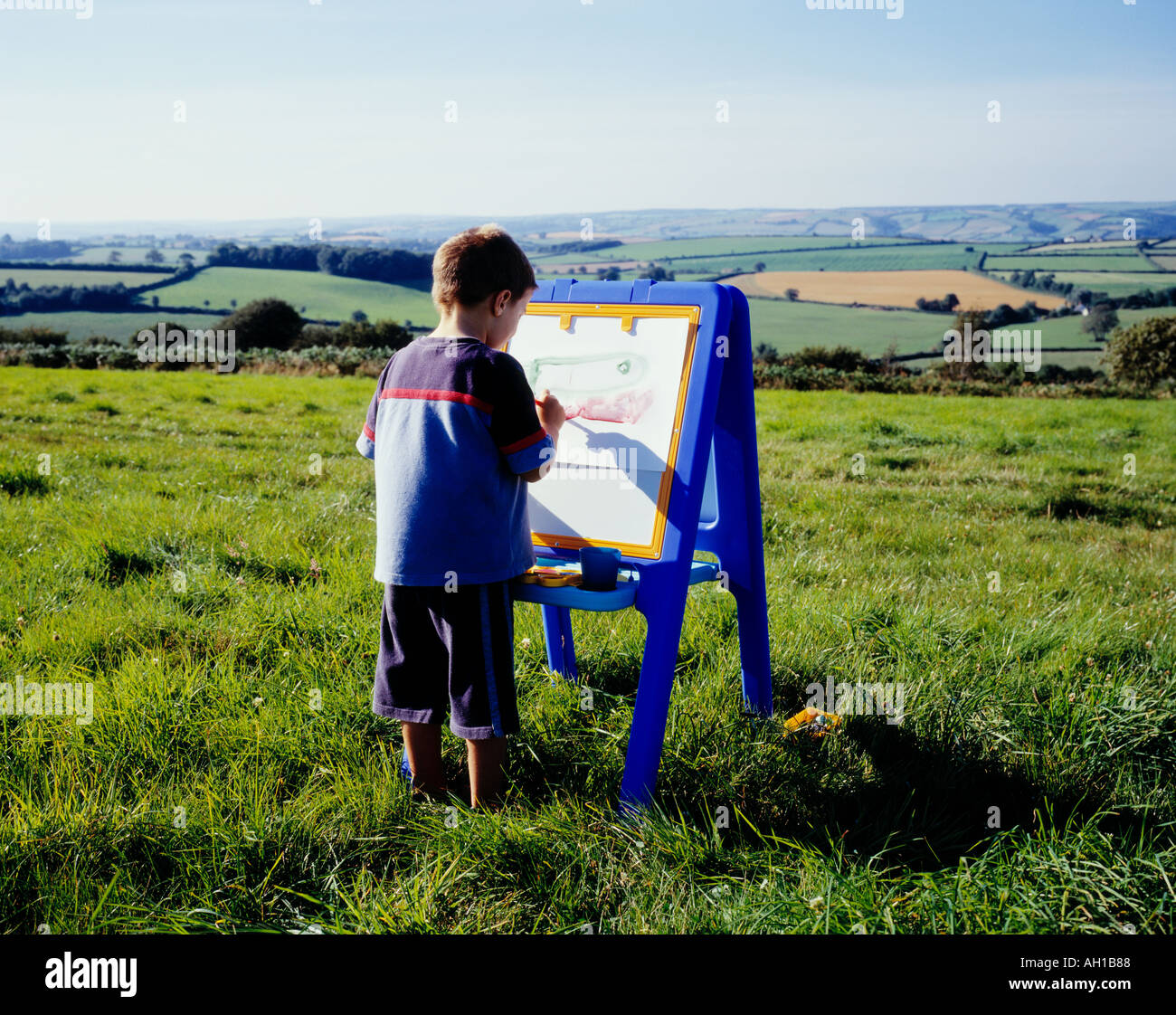 Young boy painting in field Devon England U K Stock Photo - Alamy