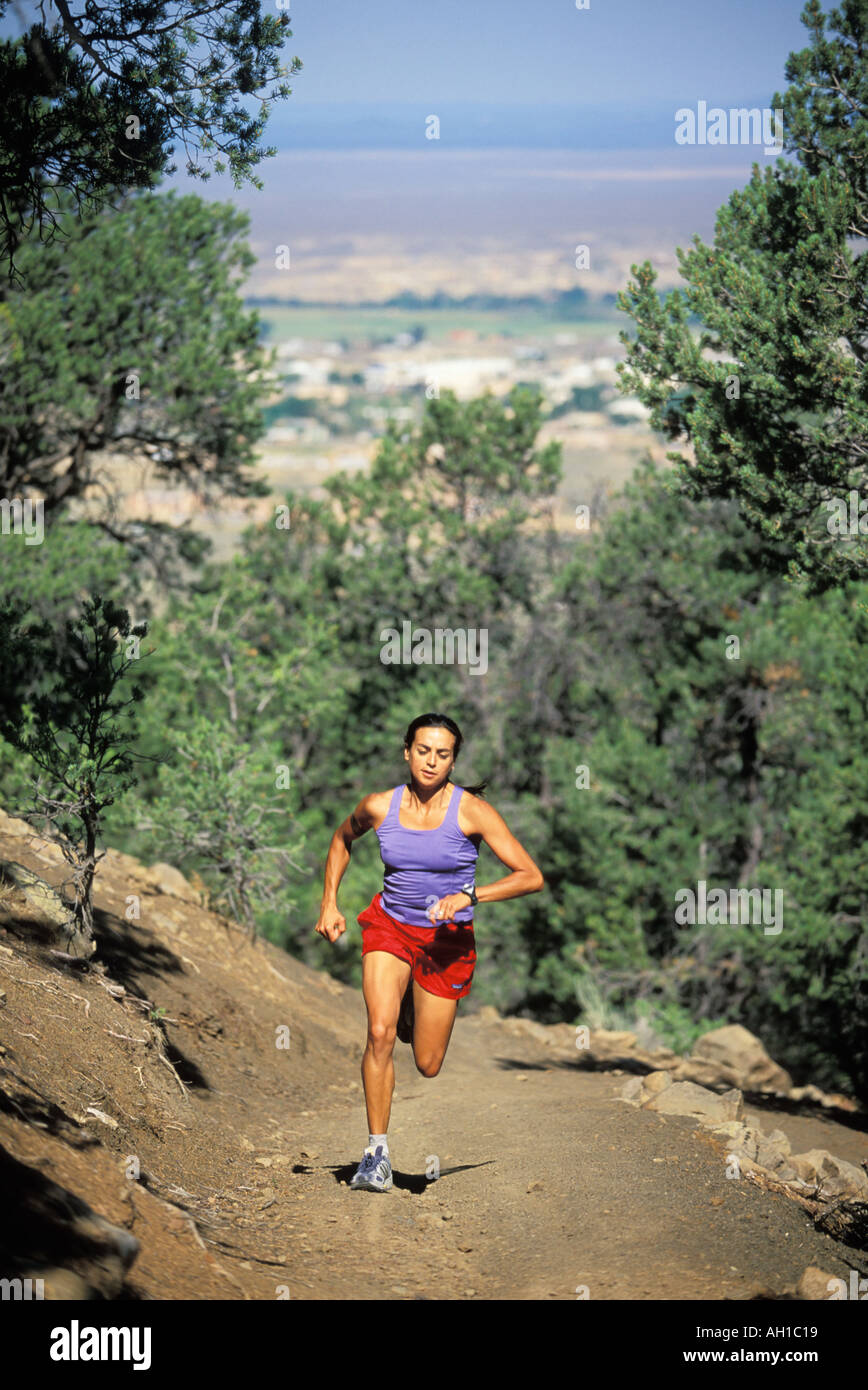 Female trail running on forested trail Stock Photo - Alamy