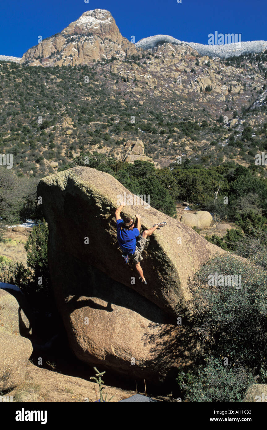Male rock climber climbing steep boulder Stock Photo - Alamy