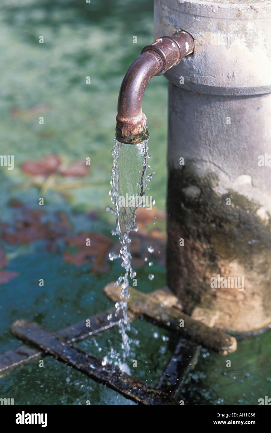 Spring water from a spout Stock Photo - Alamy