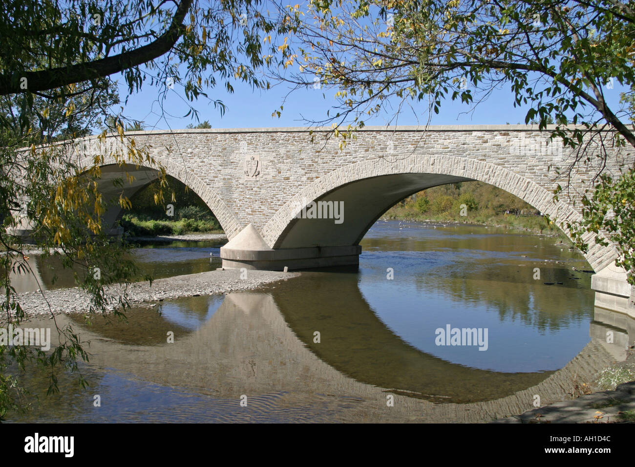 double arch stone bridge reflecting in river Stock Photo - Alamy