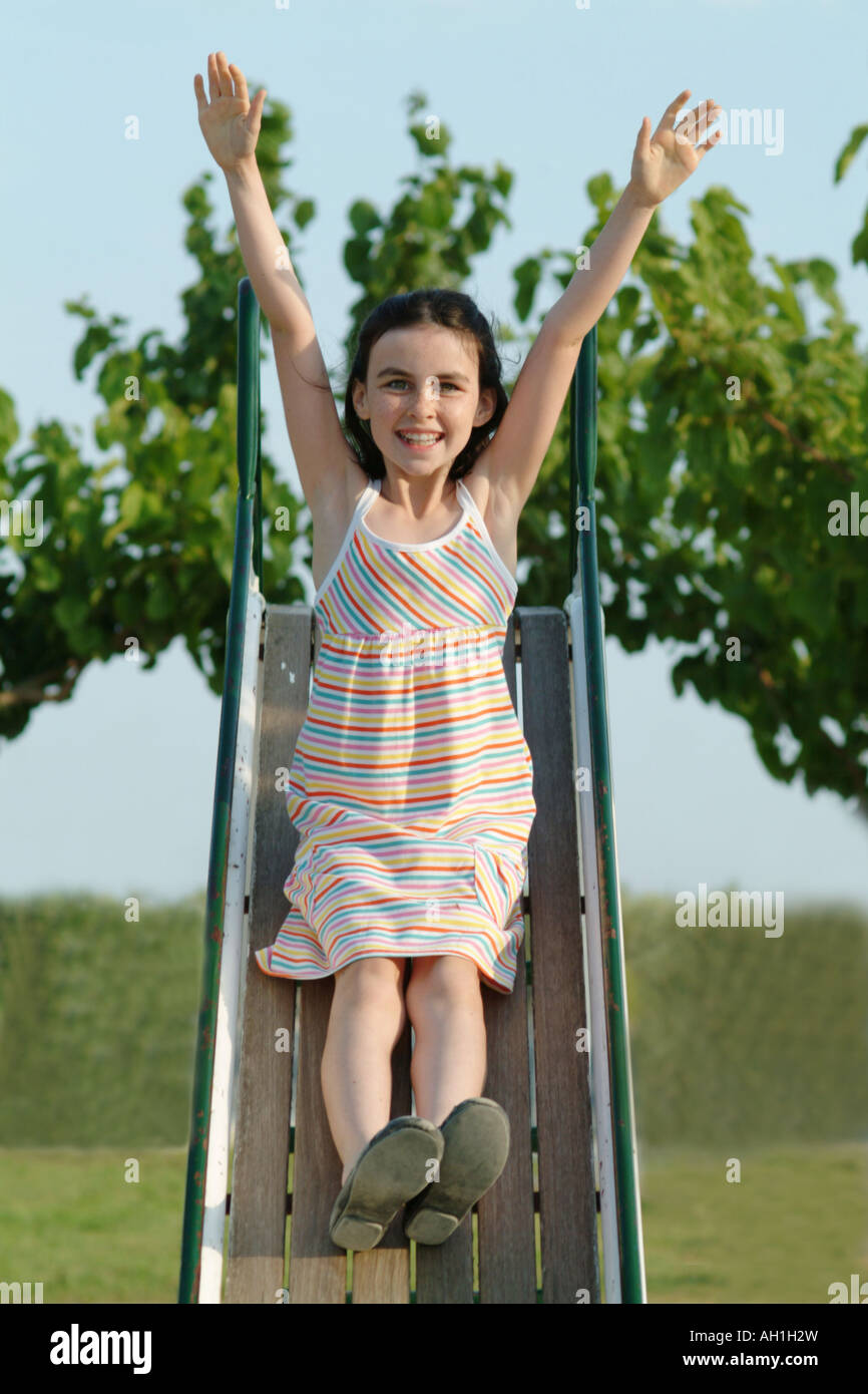 Happy girl playing on a slide Stock Photo - Alamy