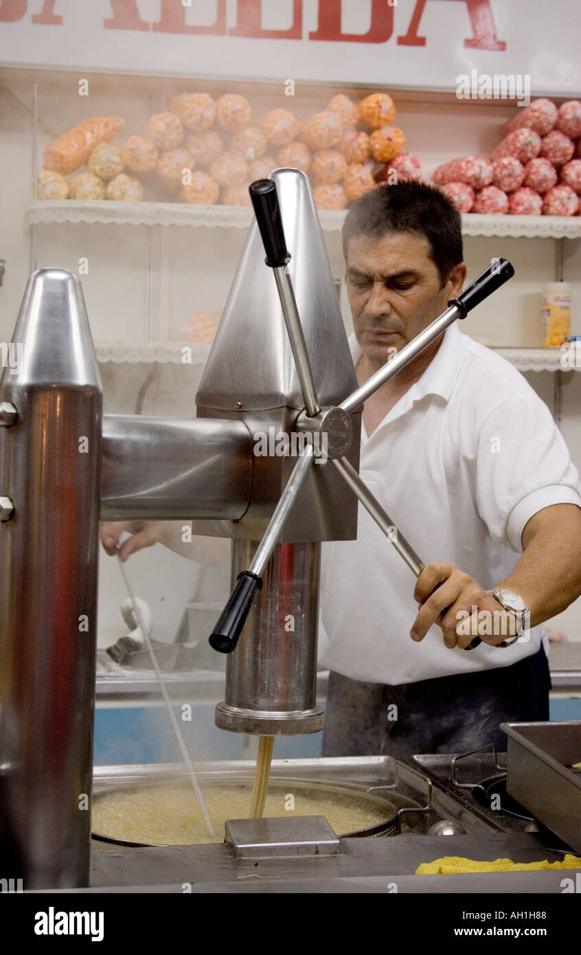 A Spanish man making churro doughnuts Stock Photo - Alamy