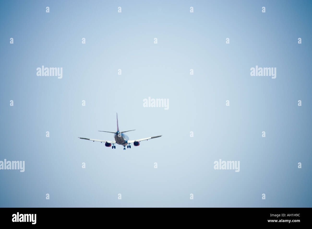 Jet plane flying into the distance Stock Photo - Alamy