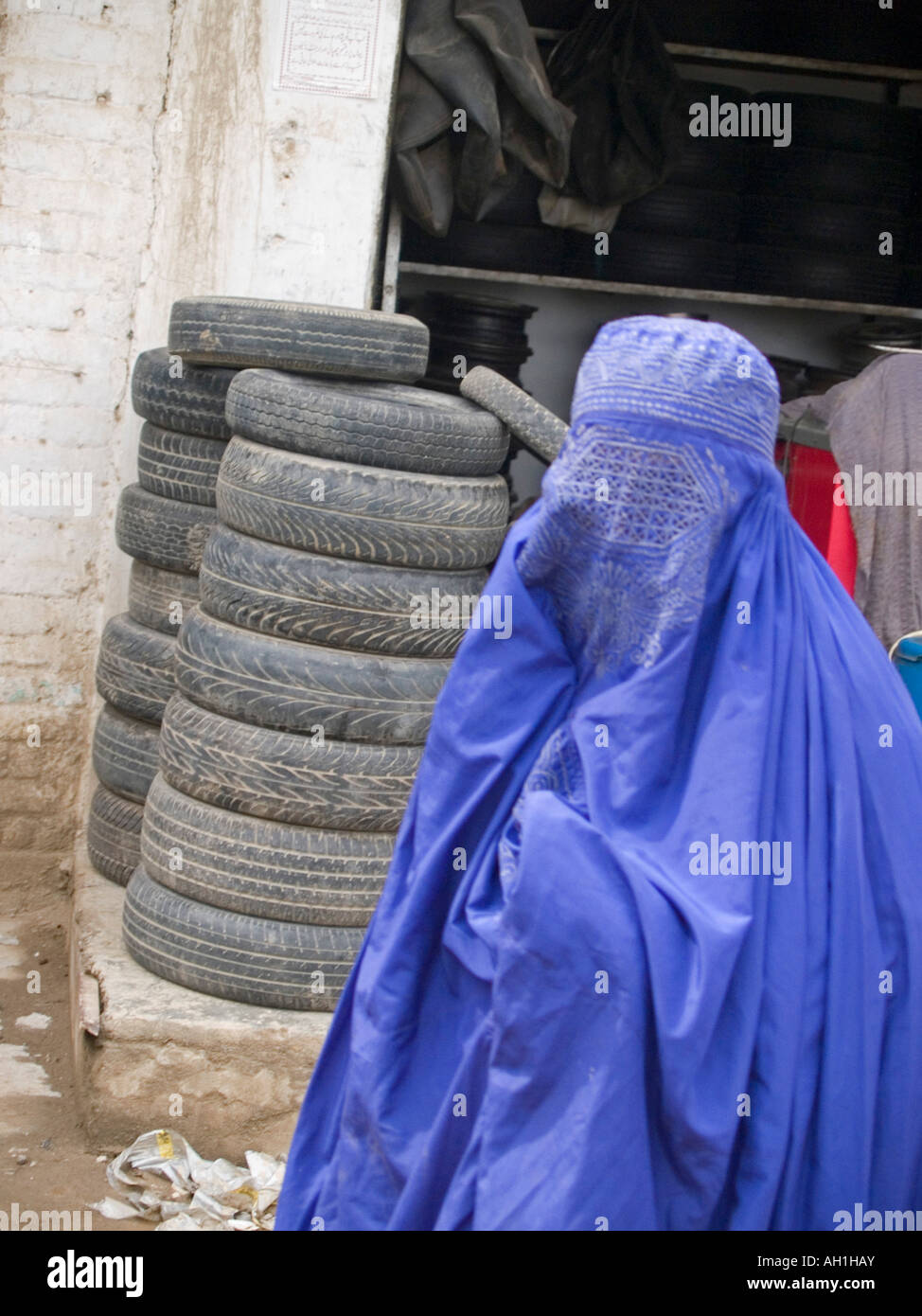 tires and burkha woman in veil in Peshawar Pakistan Stock Photo - Alamy