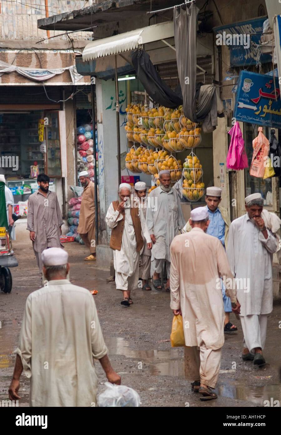 men in shalwar kameez walk through the old bazaar of Peshawar Pakistan ...