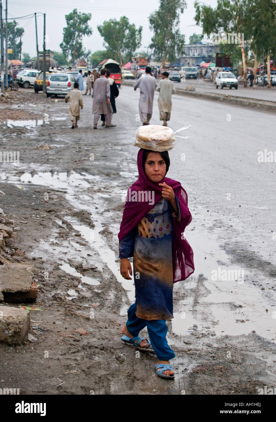 Afghan refugee carrying bread on her head Peshawar Pakistan Stock Photo ...