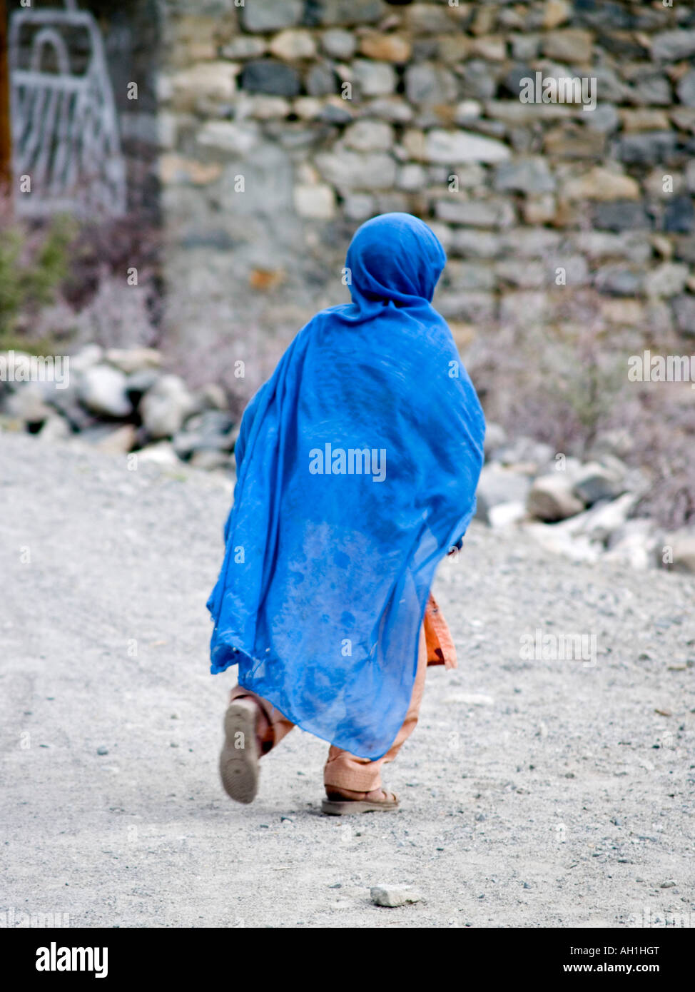 Pakistani girl in a blue shawl running Stock Photo - Alamy