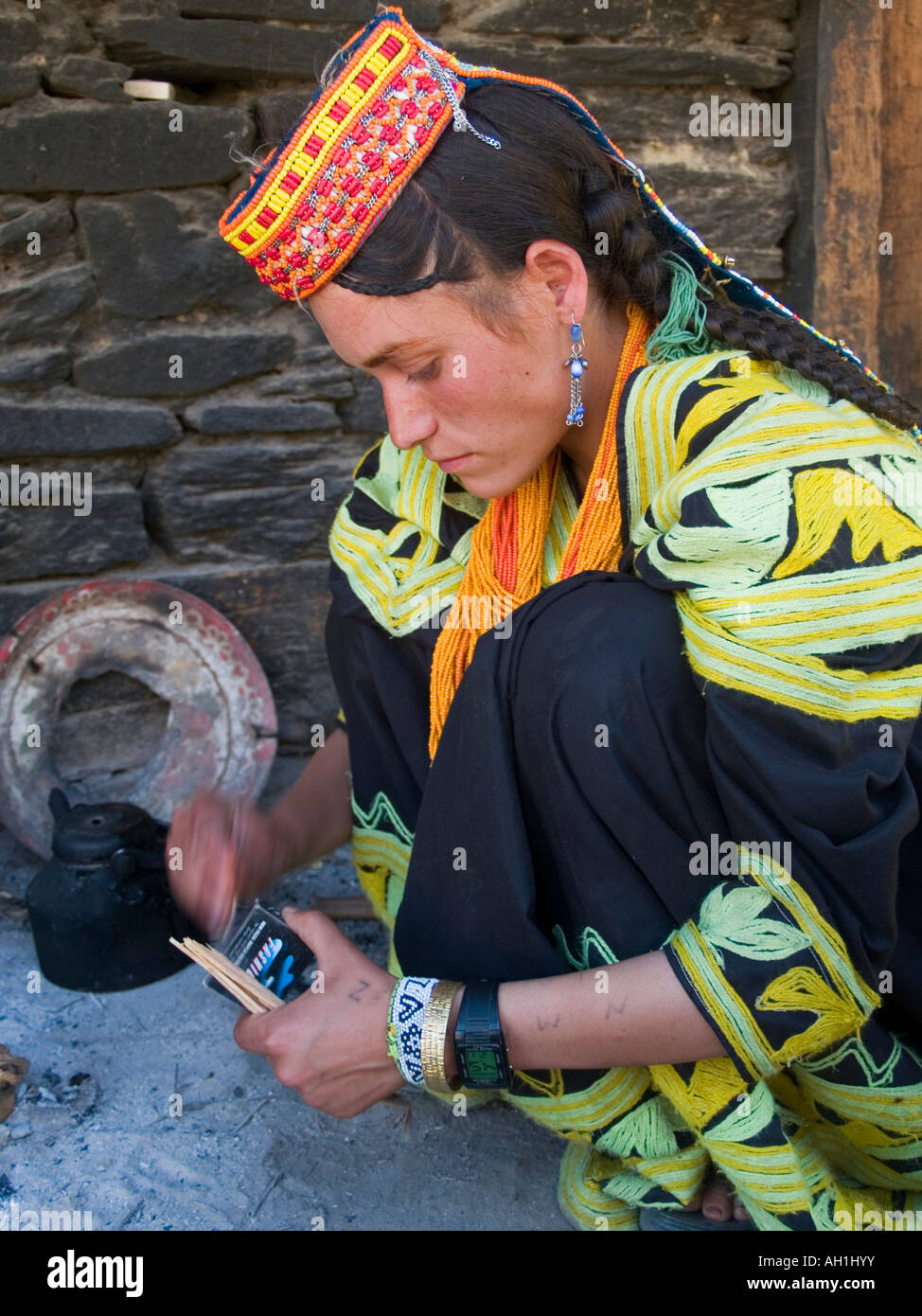 A Kalasha woman prepares to start a fire Stock Photo - Alamy