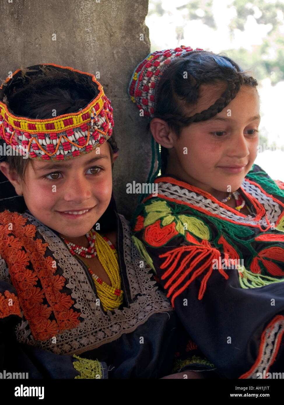 Smiling Kalasha girls sitting in the Rumbur Valley, Pakistan Stock ...