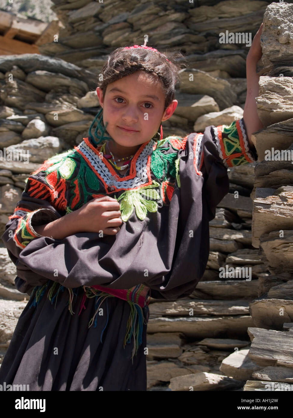 Kalasha girl against a stone wall Rumbur Valley Chitral, Pakistan Stock ...