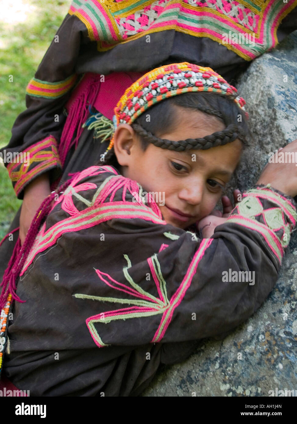Little Kalasha girl hugging a stone, Chitral, Pakistan Stock Photo - Alamy