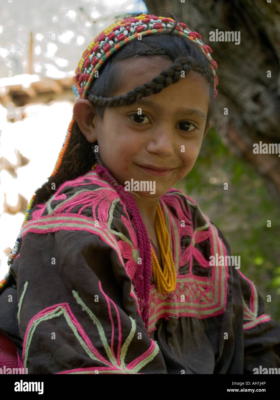 A Kalasha girl smiling in the Rumbur Valley Pakistan Stock Photo - Alamy