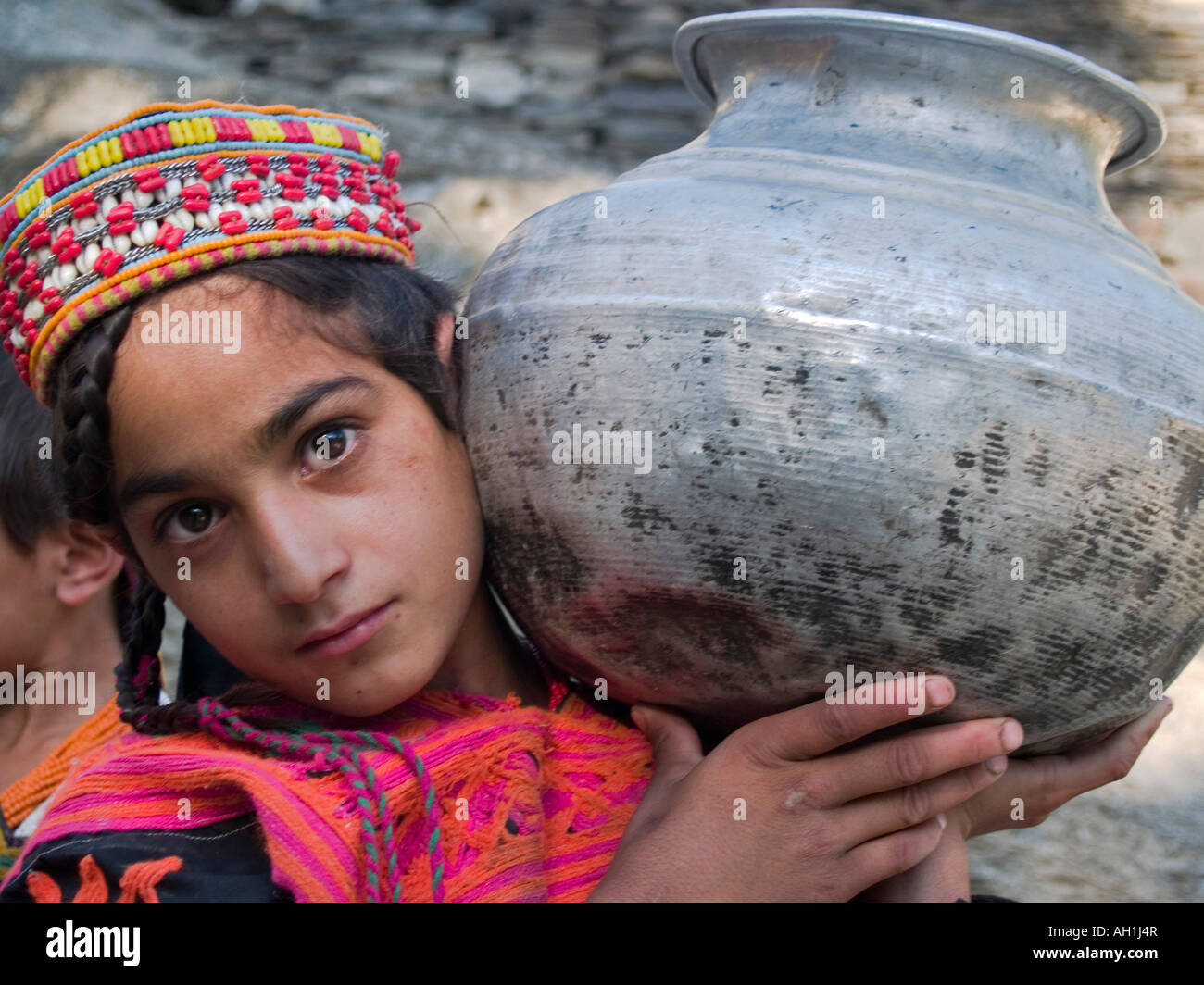 A Kalasha girl and her water jug Rumbur Valley Pakistan Stock Photo - Alamy