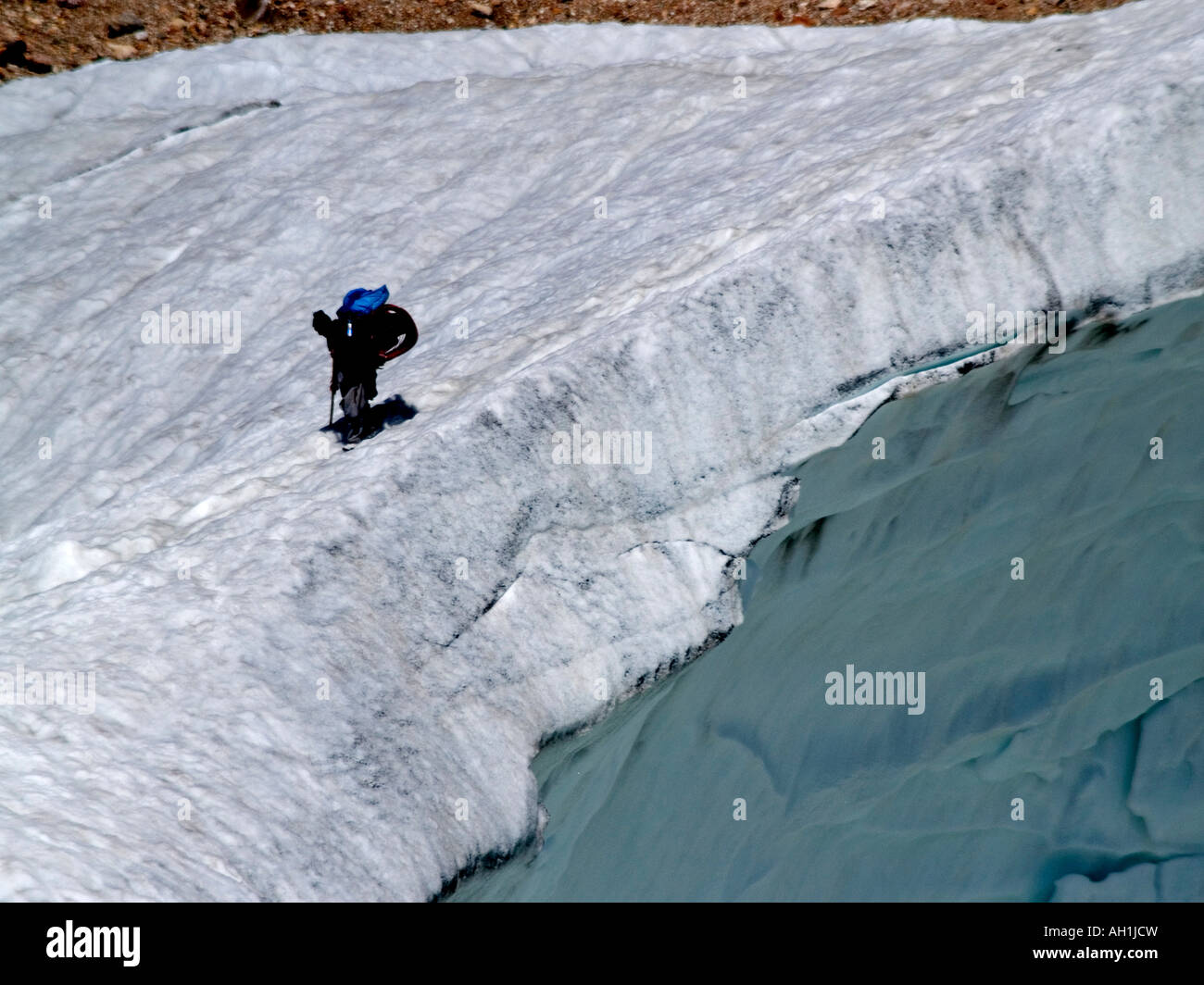 loaded porter on a scary snowbridge descending from K2 Basecamp ...