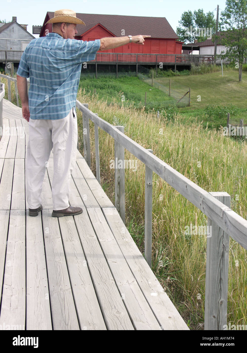 Man Pointing From Wooden Walkway Stock Photo - Alamy